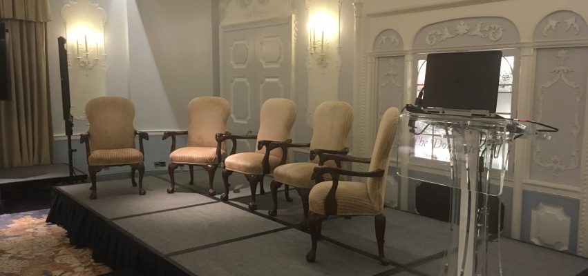 FOUR EMPTY CHAIRS AND LECTURN - Ian Mansfield